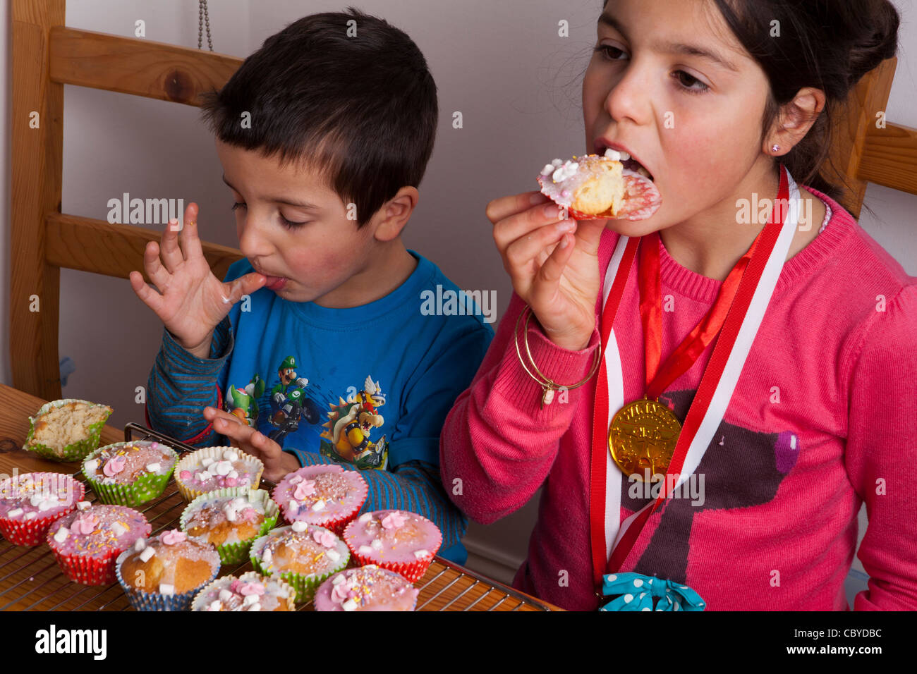 Siblings making cupcakes together Stock Photo - Alamy