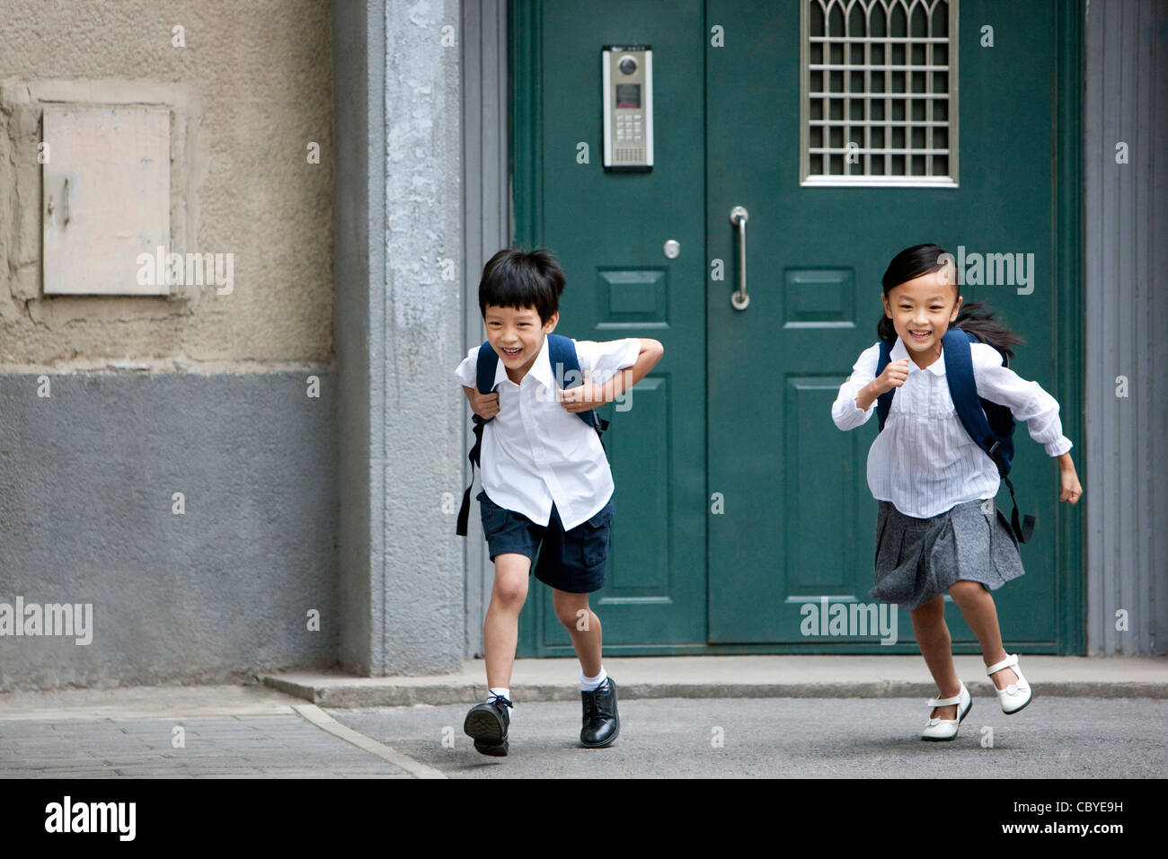 Children running to school Stock Photo - Alamy