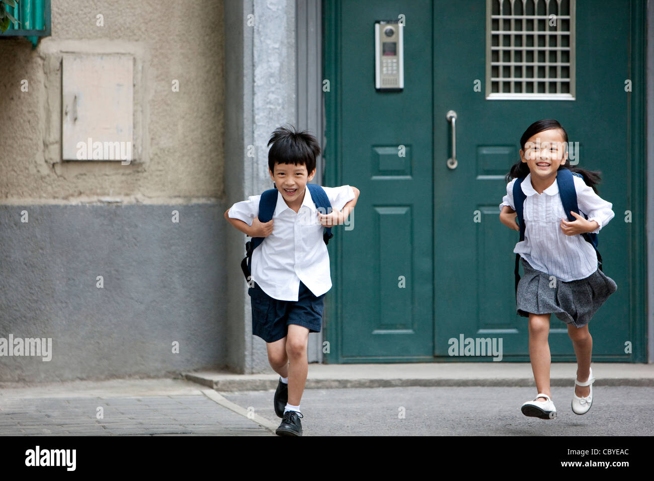 Children running to school Stock Photo - Alamy