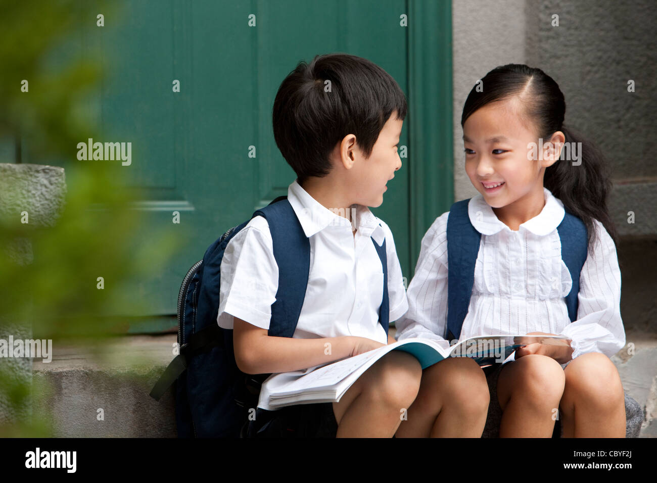 Two school children studying outside Stock Photo - Alamy