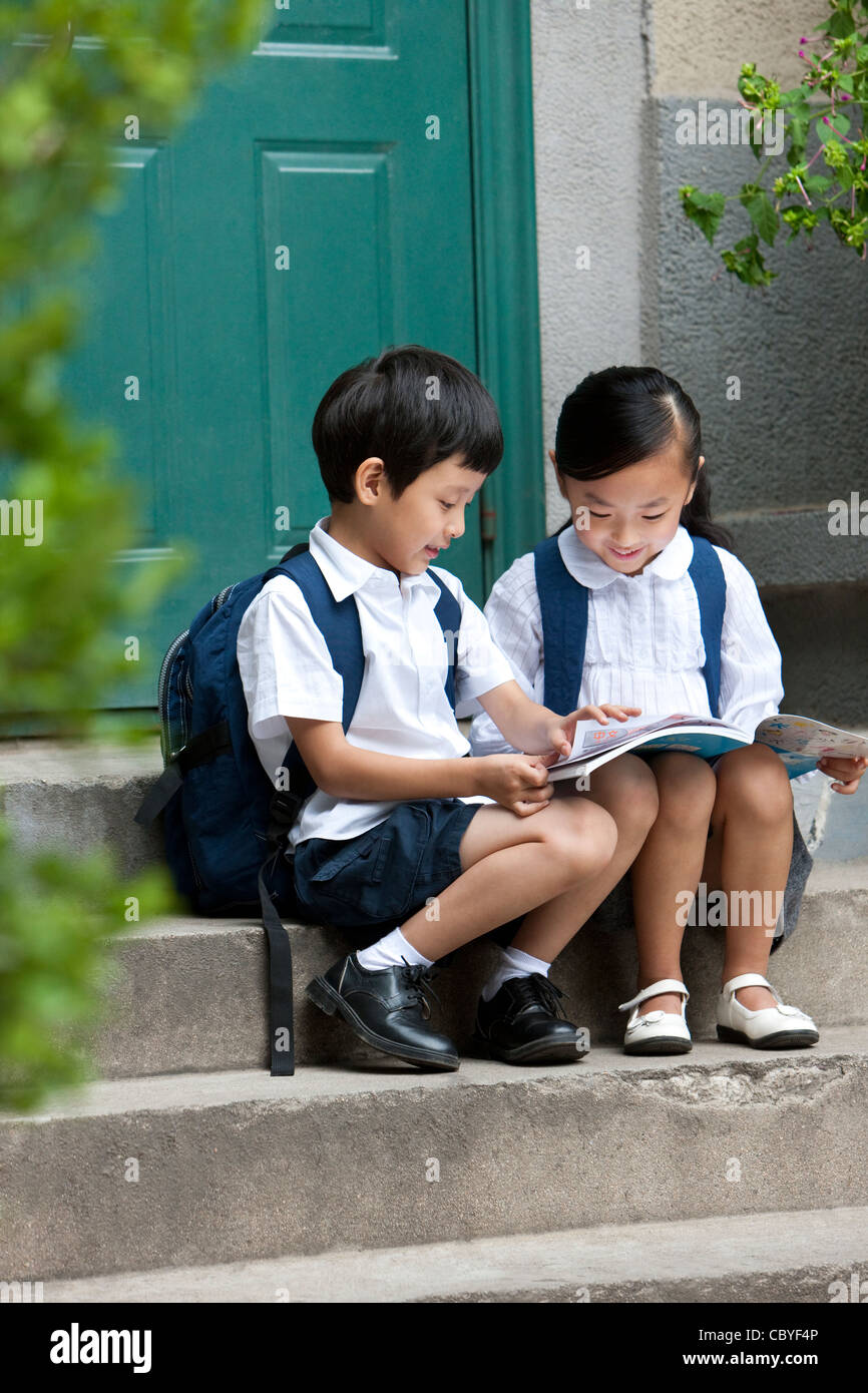 Two school children studying outside Stock Photo - Alamy