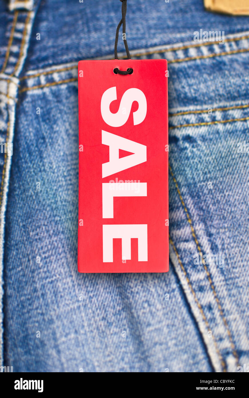 Red Sale Sign With Jeans in Background Stock Photo - Alamy