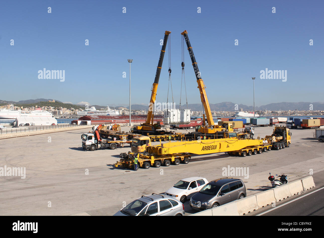 Two heavy lift cranes transferring large electical transformer from low ...