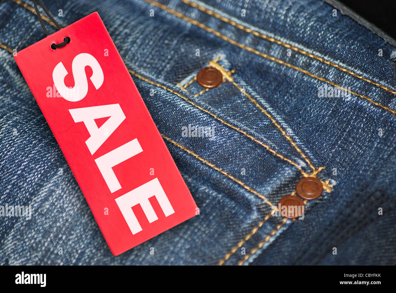 Red Sale Sign With Jeans in Background Stock Photo - Alamy