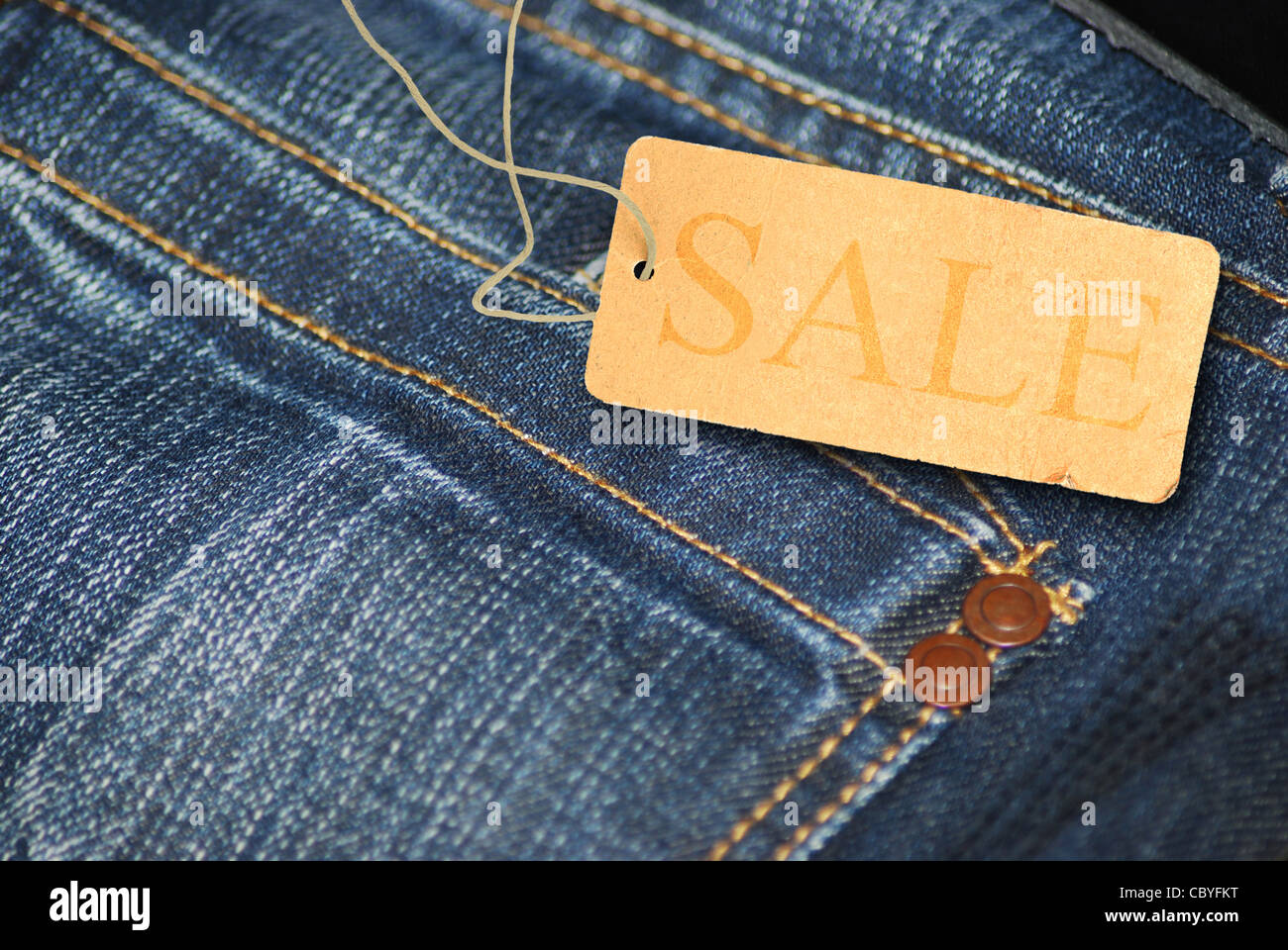 Sale Sign With Jeans in Background Stock Photo - Alamy