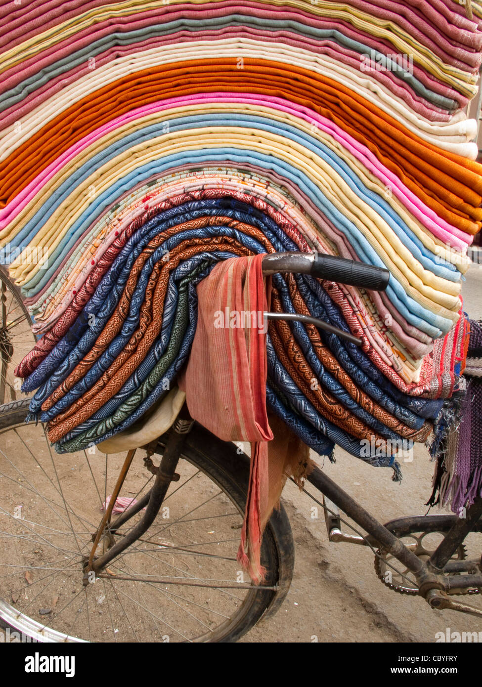 India, Bihar, Bodhgaya, stack of textiles for sale to pilgrims on ...