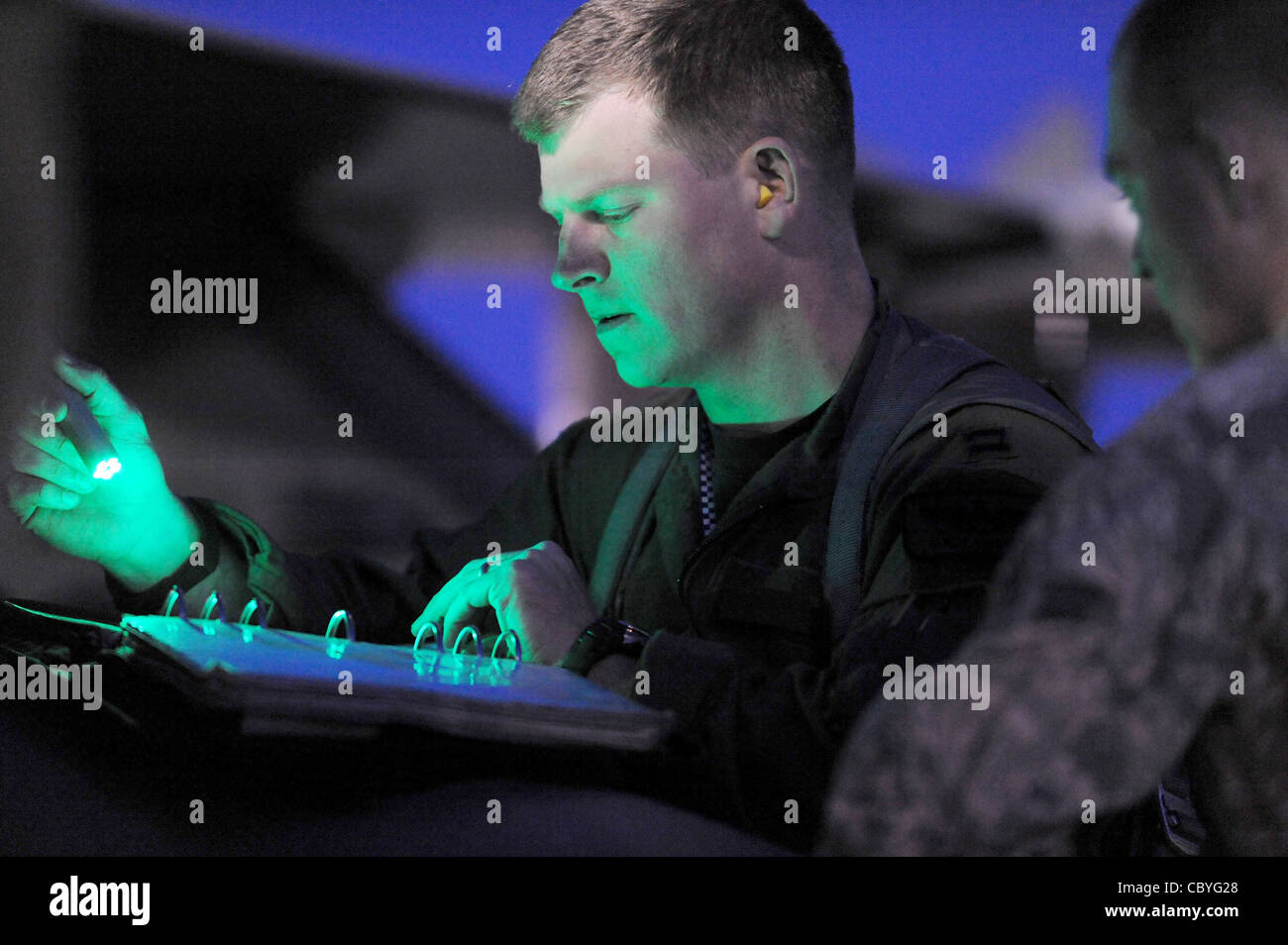 Capt. Mathew Russell goes over pre-flight paperwork before a night ...