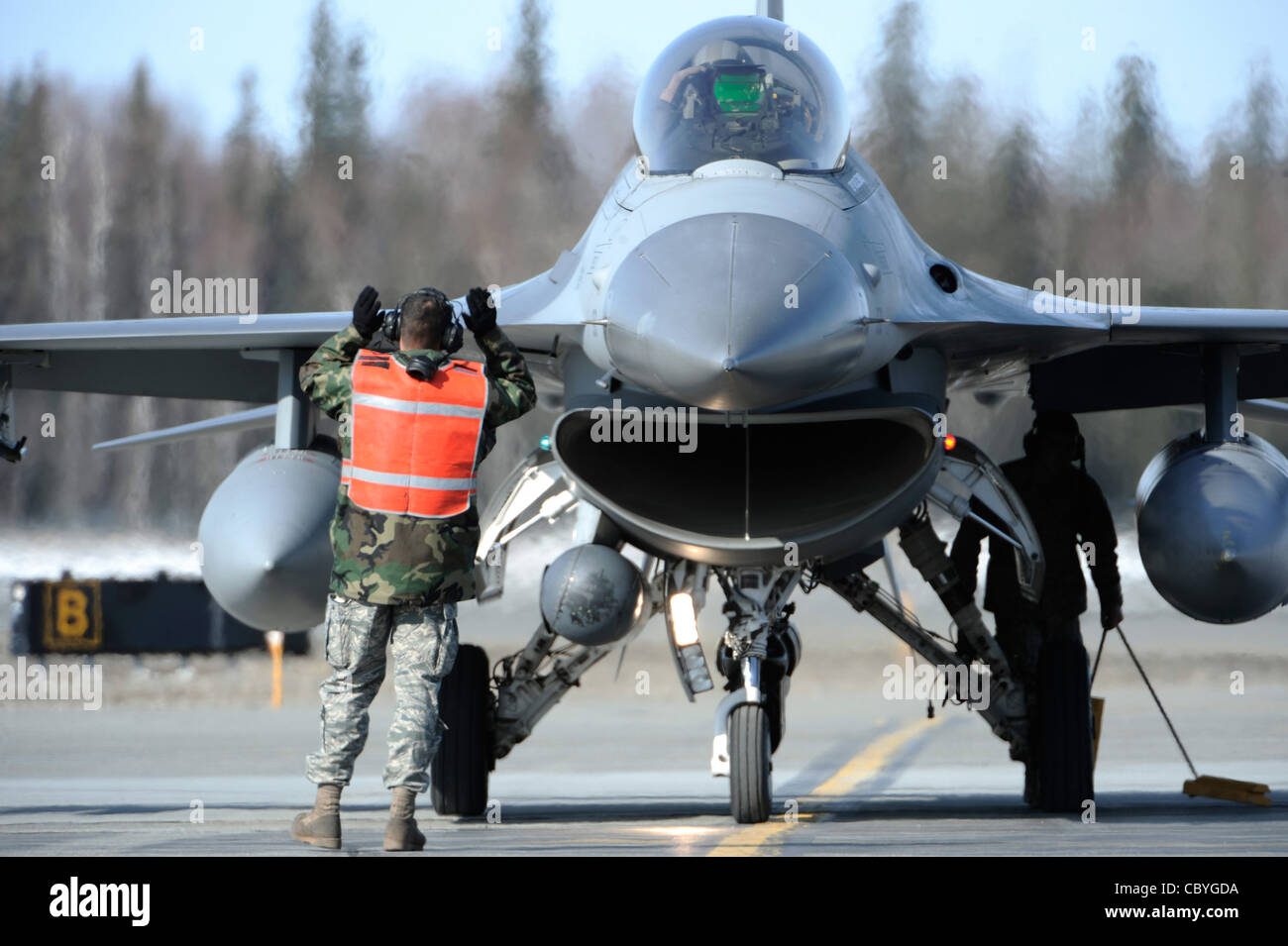 Staff Sgt. Jason Lewey marshals an F-16 Fighting Falcon returning from ...