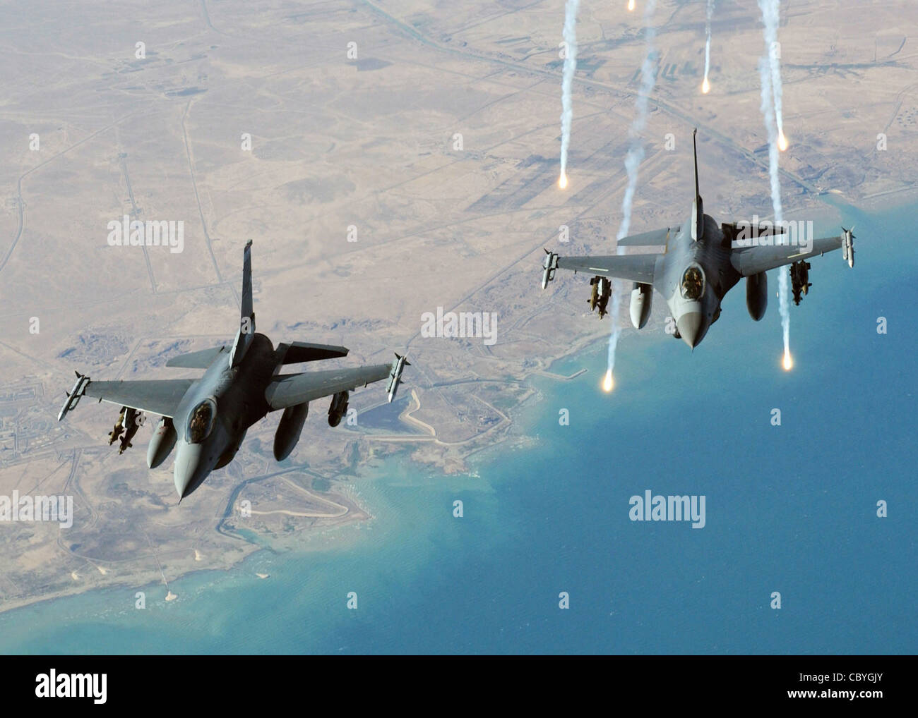 An F-16 Fighting Falcon launches electronic countermeasure flares ...