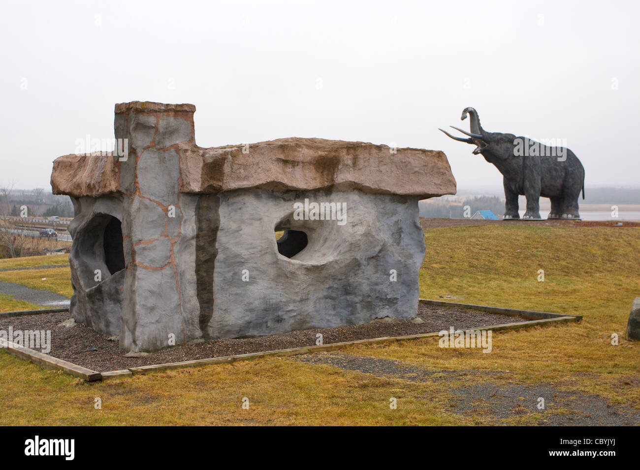 Pre-historic Mastodon model behind cave man house, Stewiacke, Nova ...