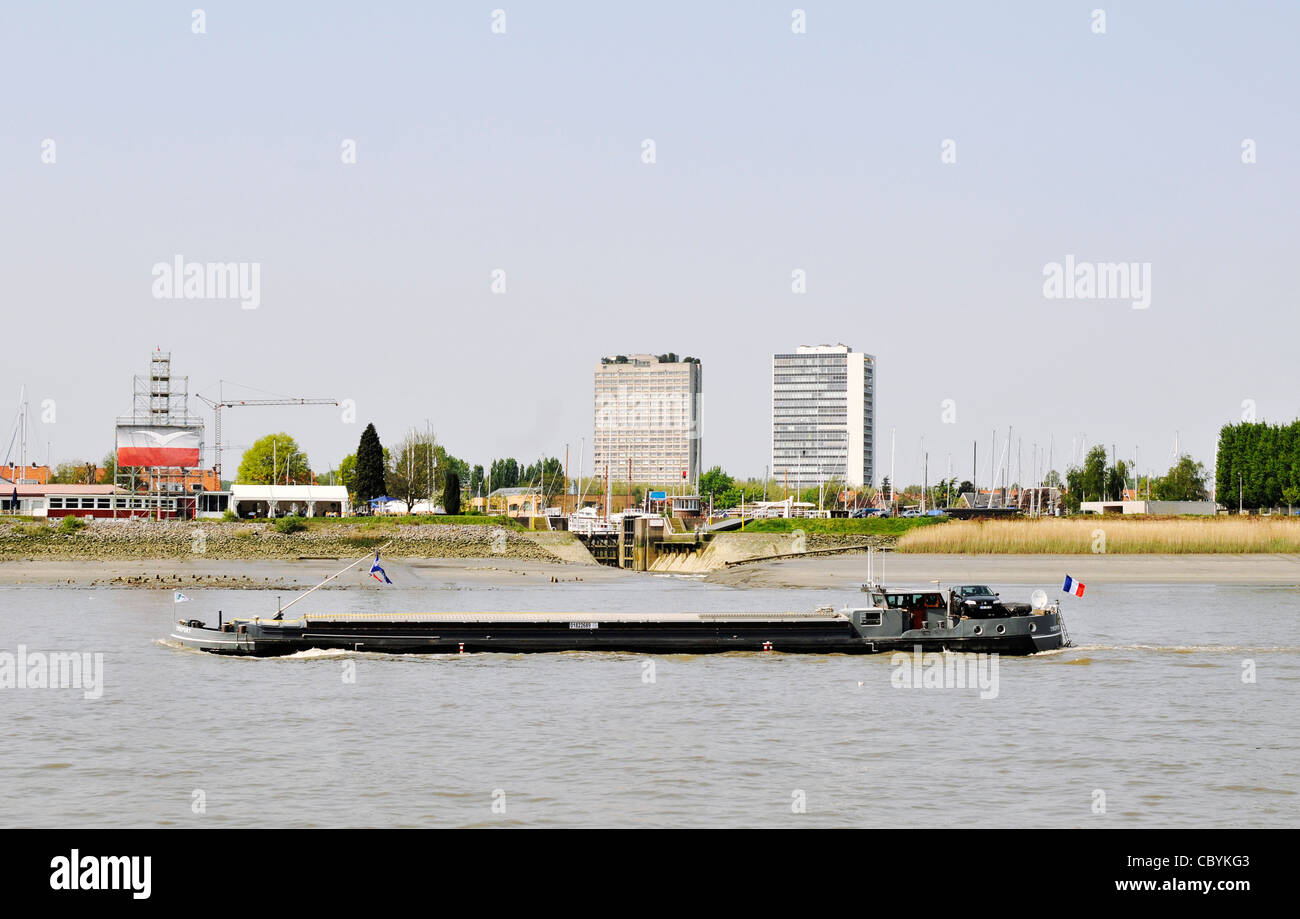 A barge travels down the Schelde river in Antwerp, in the background is ...
