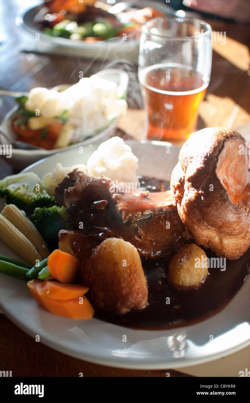 A typical roast beef Sunday lunch with yorkshire pudding, vegetables ...