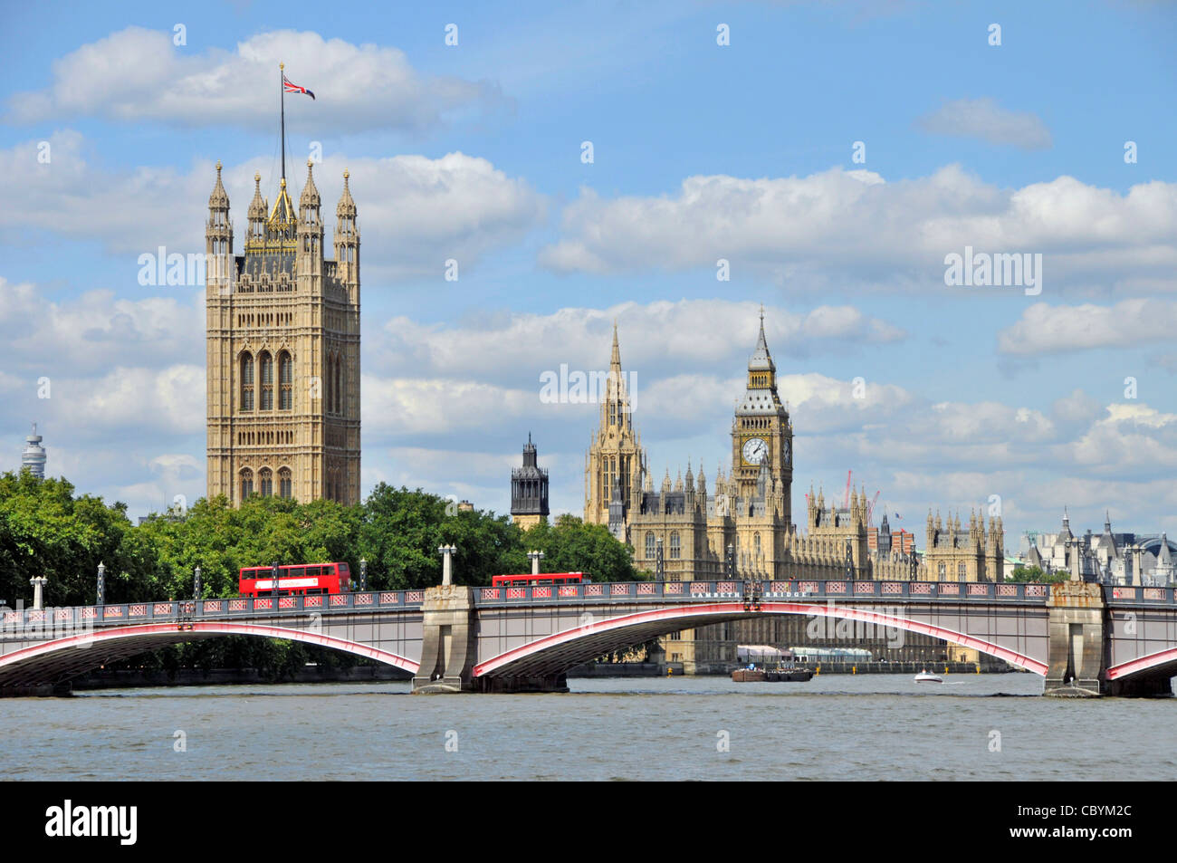 Westminster red buses on Lambeth road bridge crossing River Thames at ...