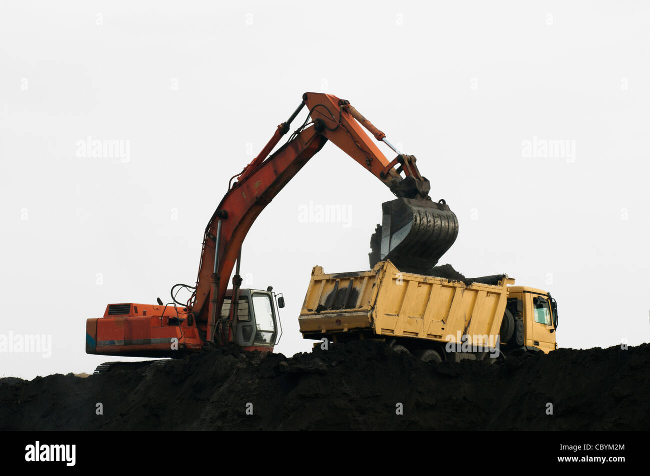 Excavator loading truck. White isolated Stock Photo - Alamy