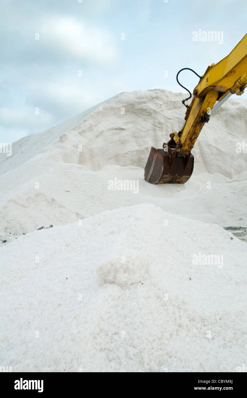 Excavator digging pile white salt Stock Photo - Alamy