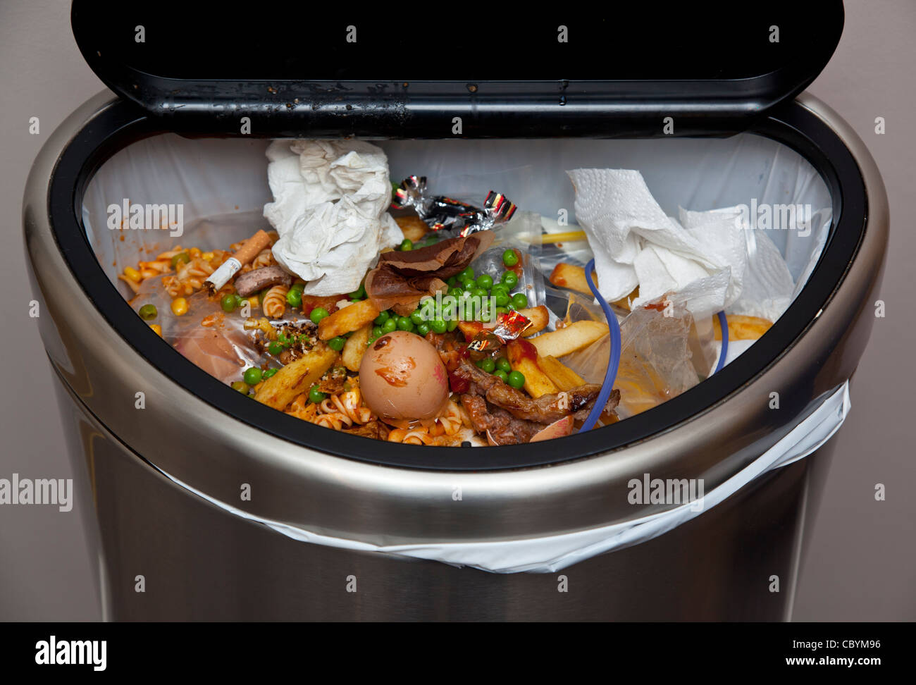 A very full domestic wast bin Stock Photo - Alamy