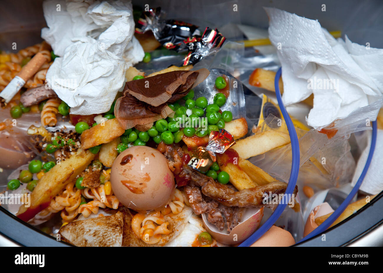 A very full domestic wast bin Stock Photo - Alamy