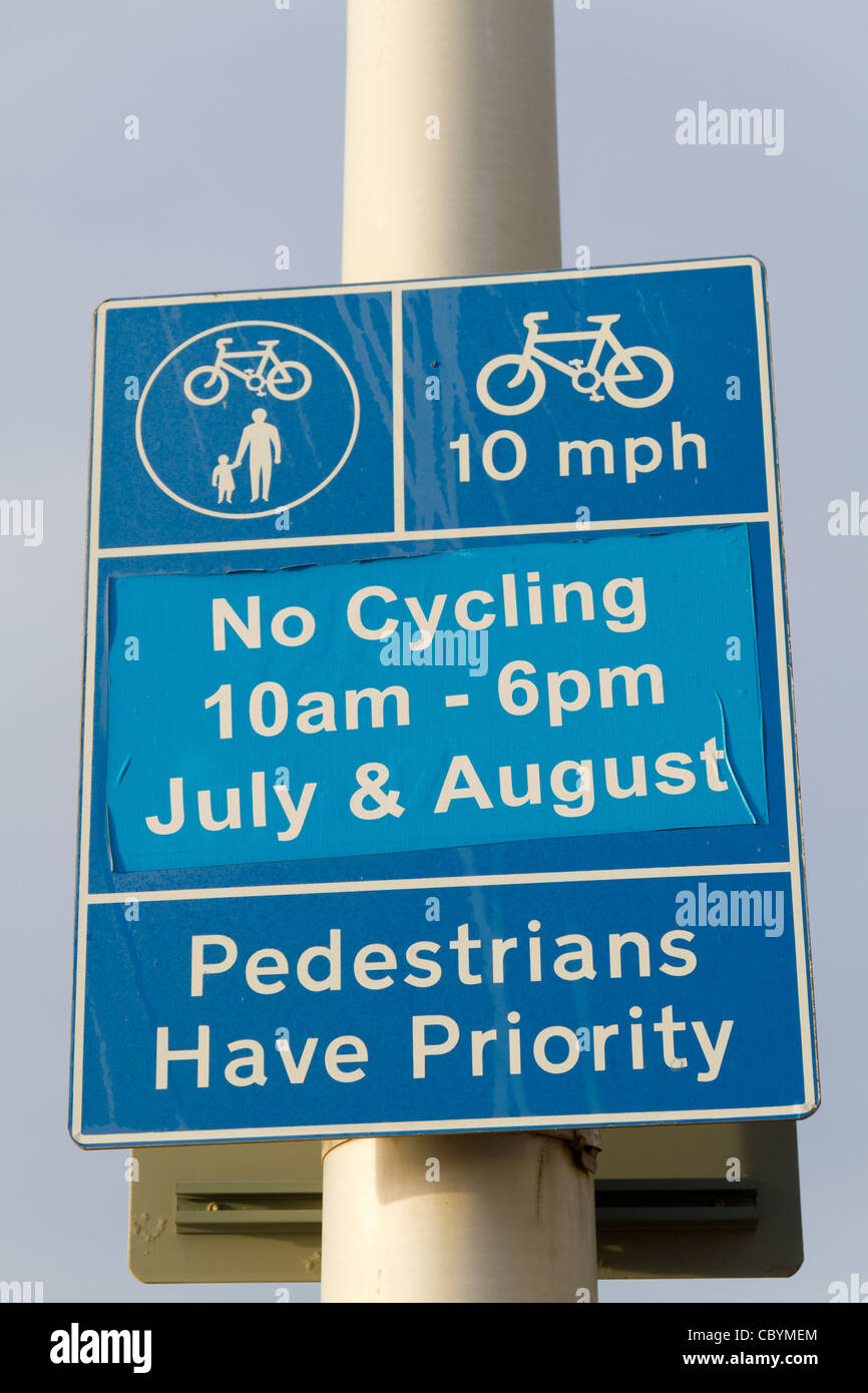 Cycling safety sign on Bournemouth promenade Stock Photo - Alamy