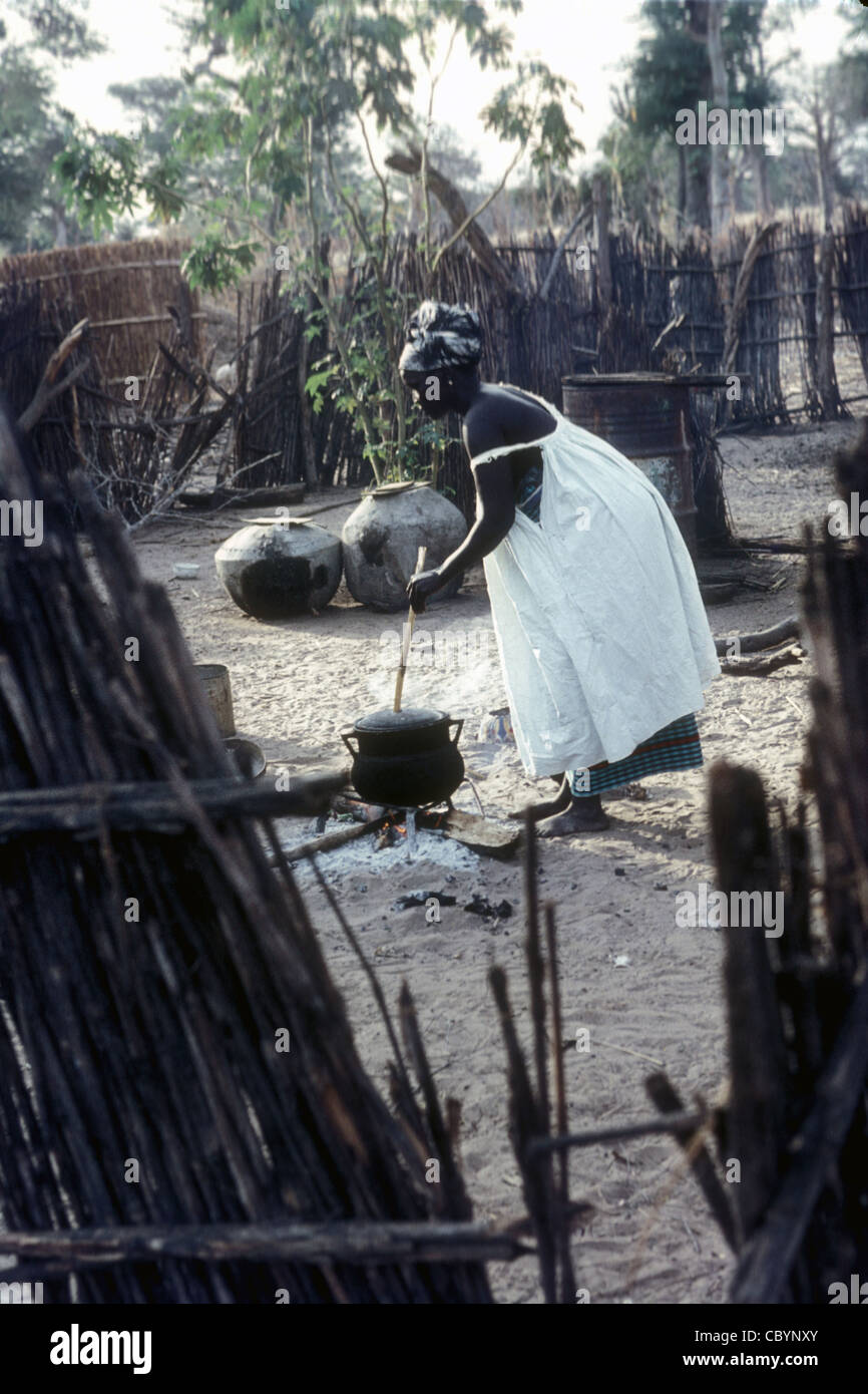 An African woman cooking in her yard in a rural village, Gambia Stock ...