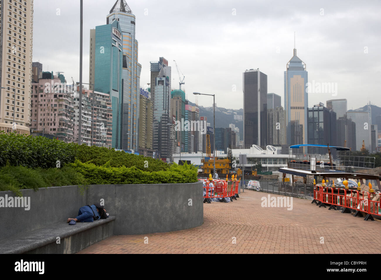 chinese man sleeping outdoors on a park bench in causeway bay hong kong ...