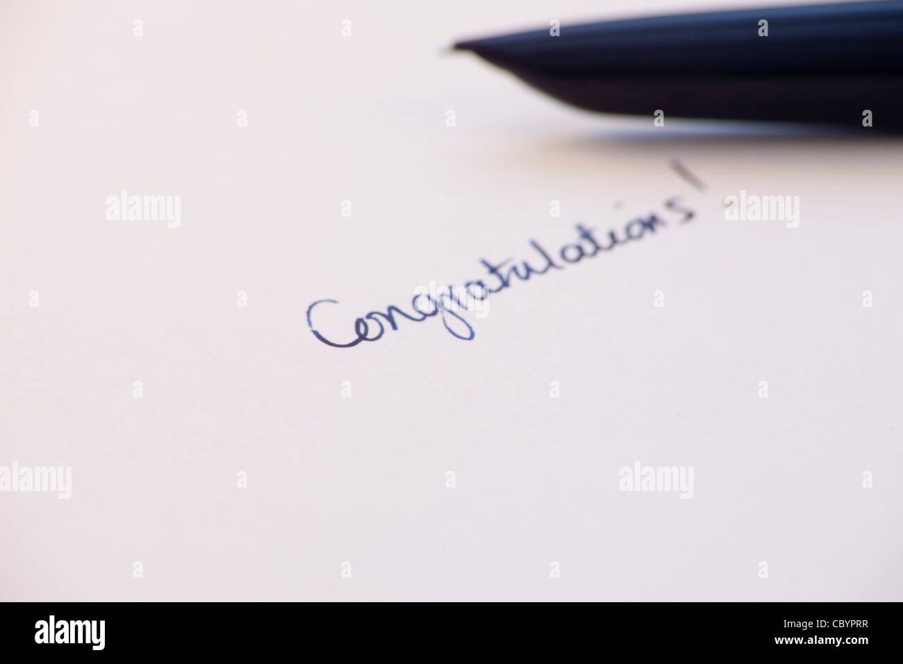 The word "Congratulations" handwritten in ink with fountain pen in ...