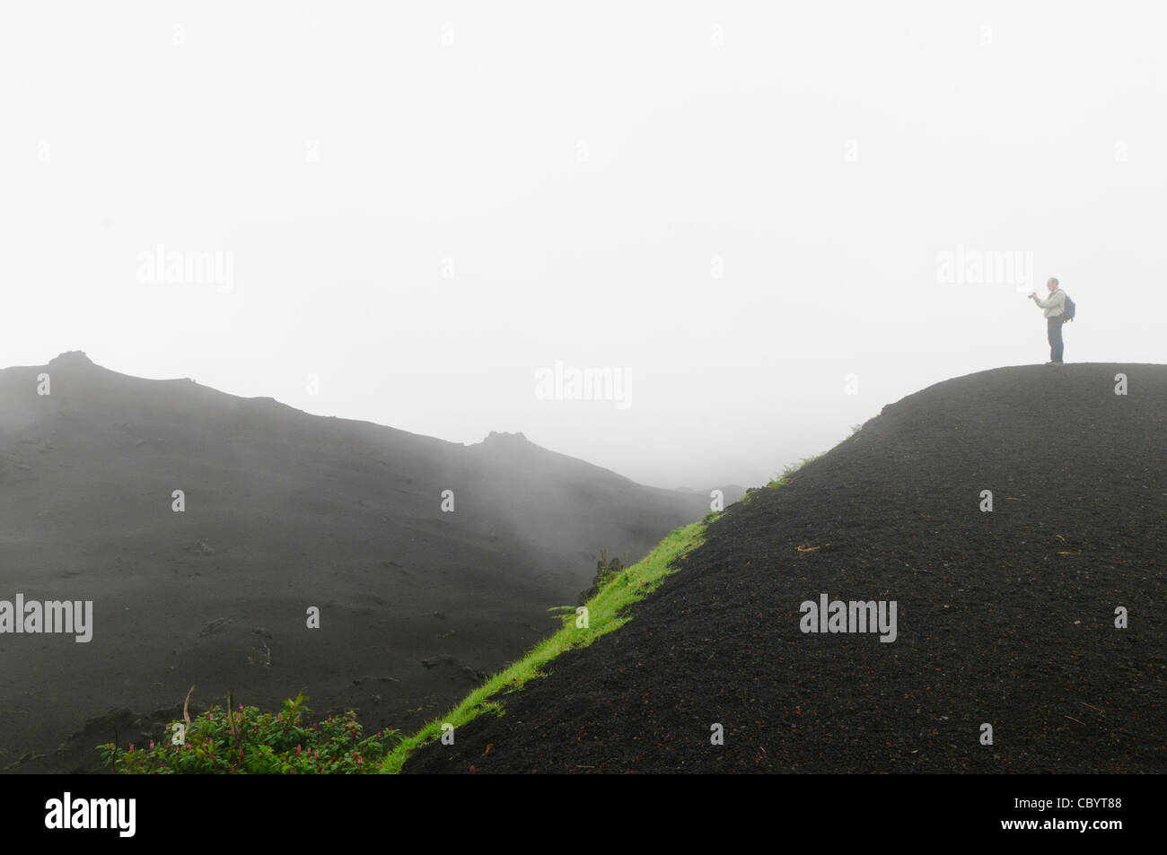 PACAYA VOLCANO, Guatemala — A hiker stands on some of the rugged ...