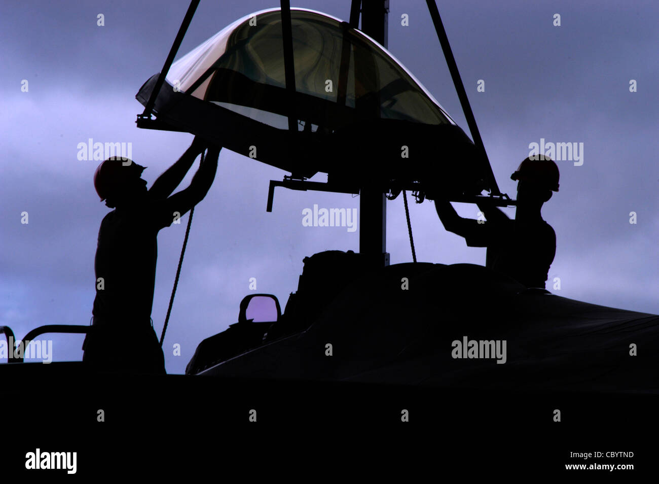 Senior Airman Ryan Ott and Staff Sgt. Tim Sullivan guide a canopy onto ...