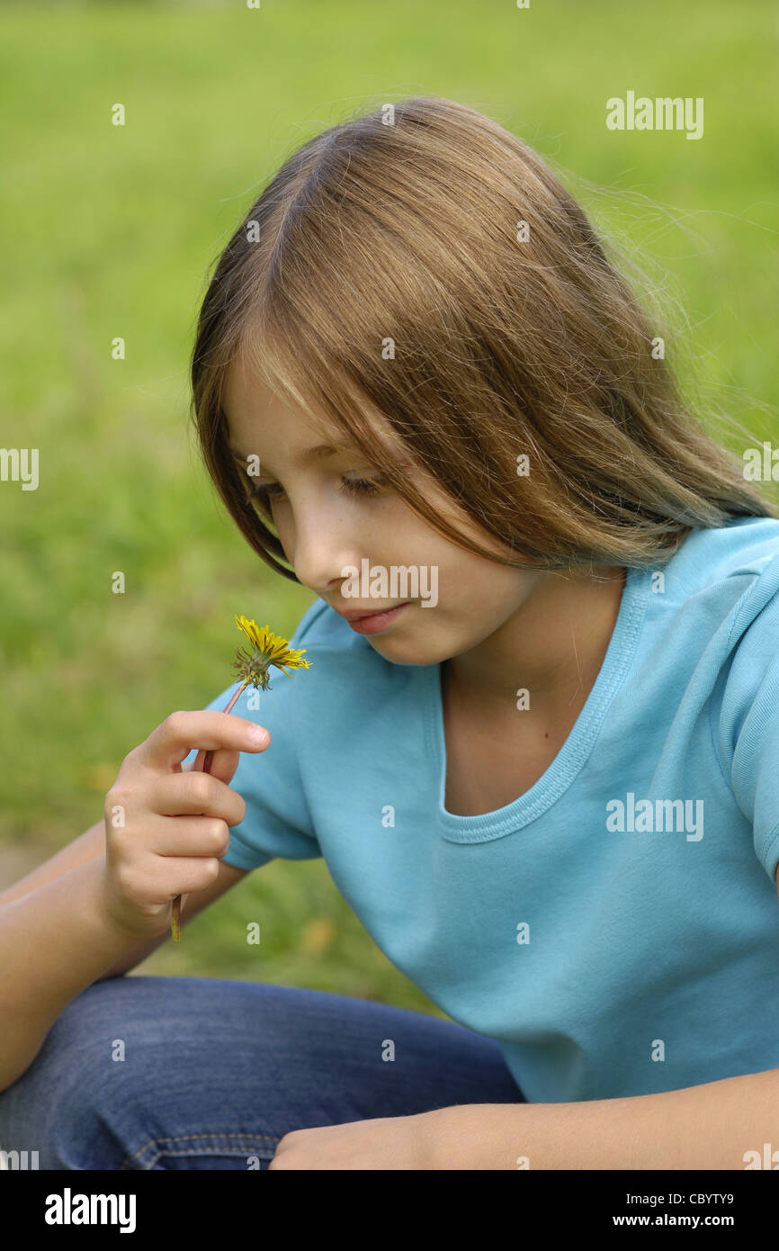 TEN YEAR OLD CHILD SNIFFING A DANDELION IN THE COUNTRYSIDE Stock Photo ...