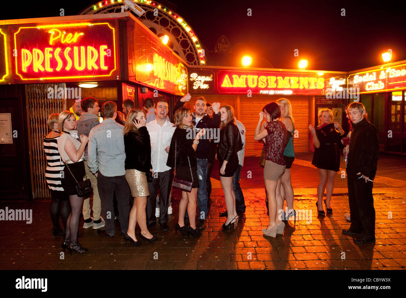 a group of Revellers celebrating the new year, 2012, in a queue line ...