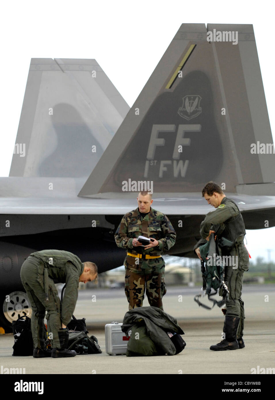 A crew chief talks to F-22 Raptor pilots after they landing Feb. 7 at ...