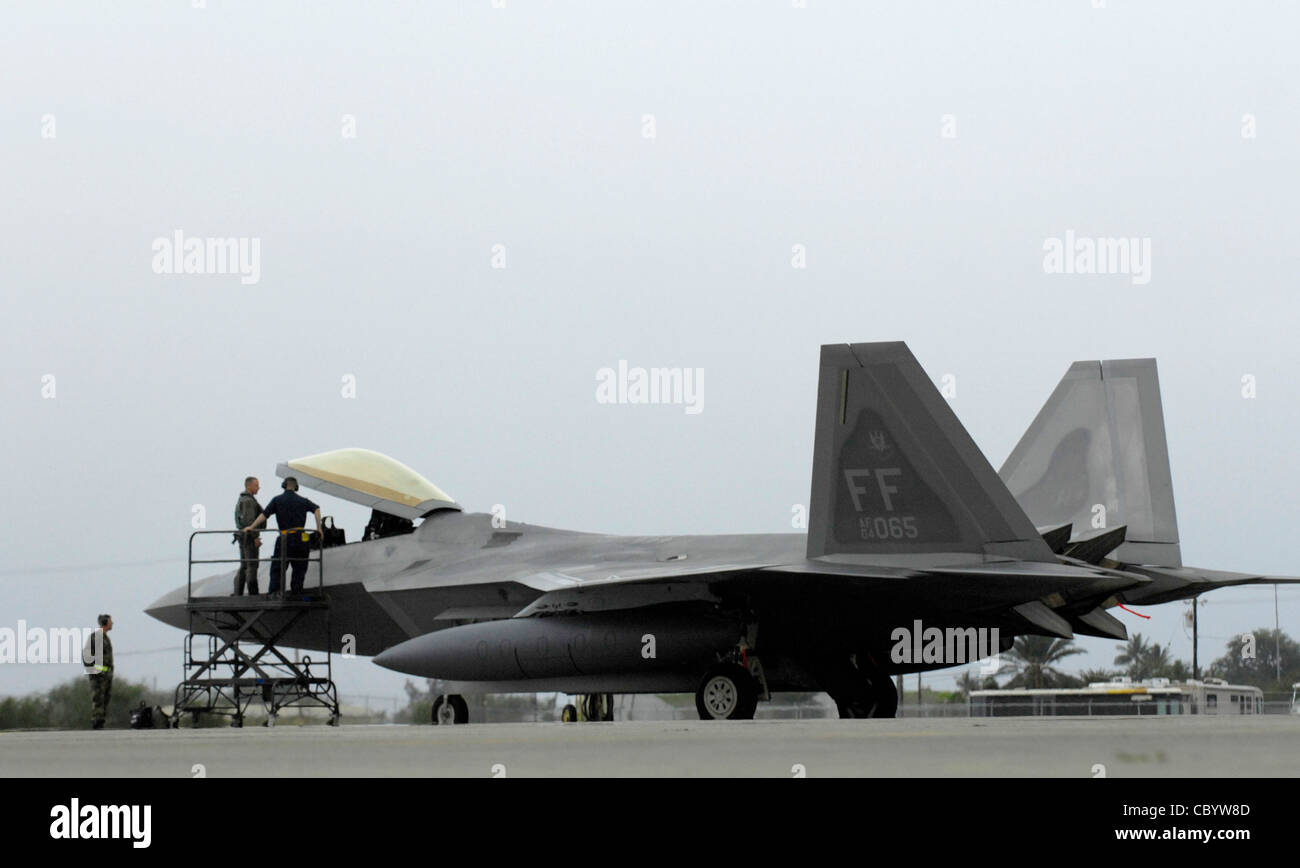 A crew chief talks to the pilot of an F-22 Raptor after parking Feb. 7 ...