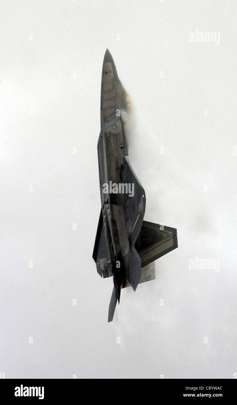 An F-22 Raptor streaks through the clouds during the Arctic Thunder air ...