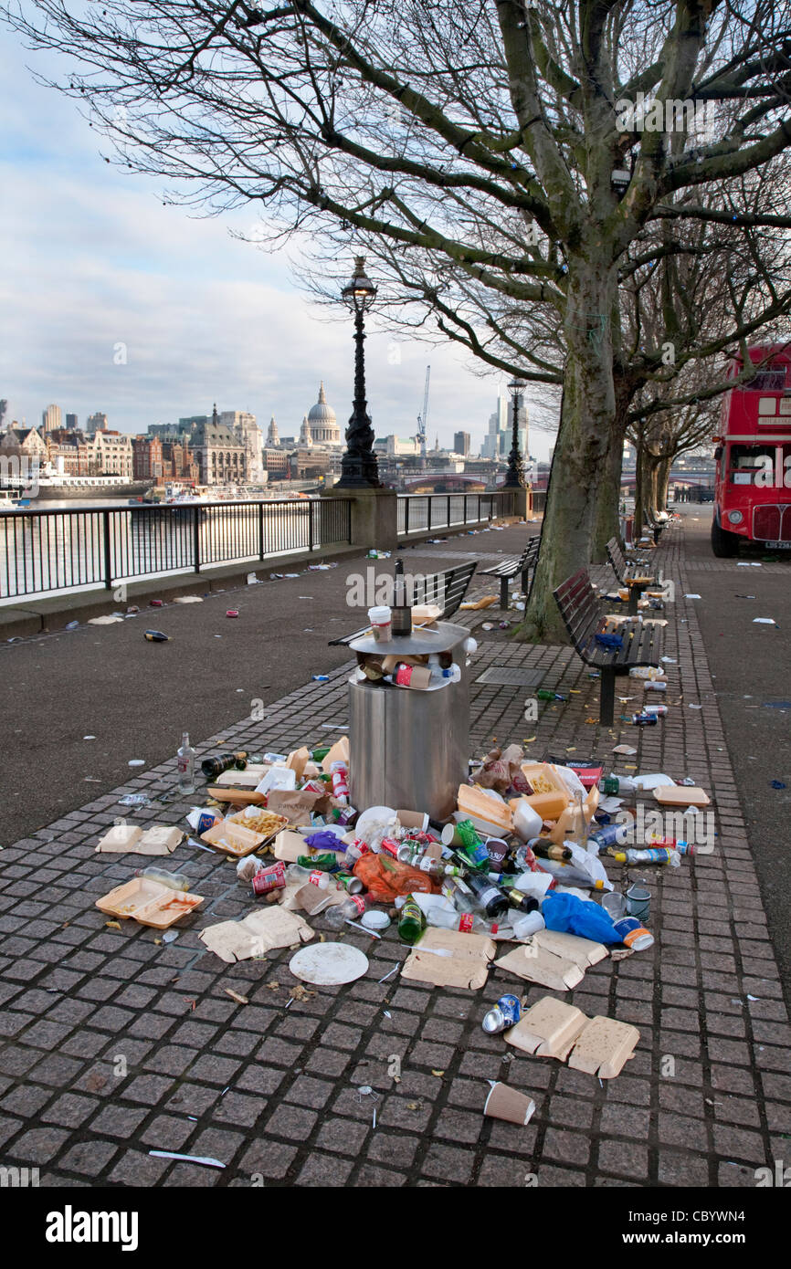 Litter on the pavement on the banks of the River Thames in central ...