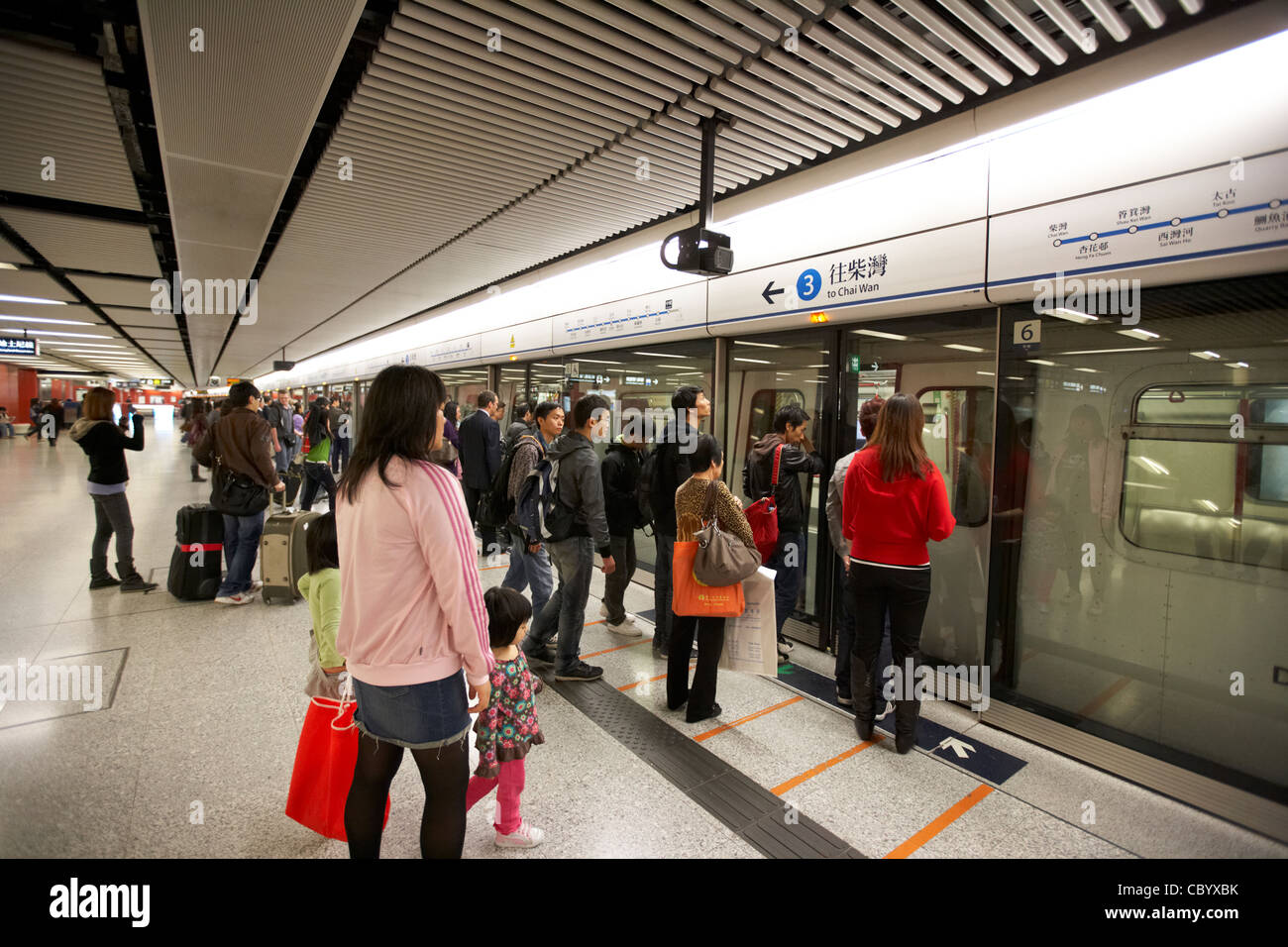 chinese people boarding underground train on hong kong central station ...