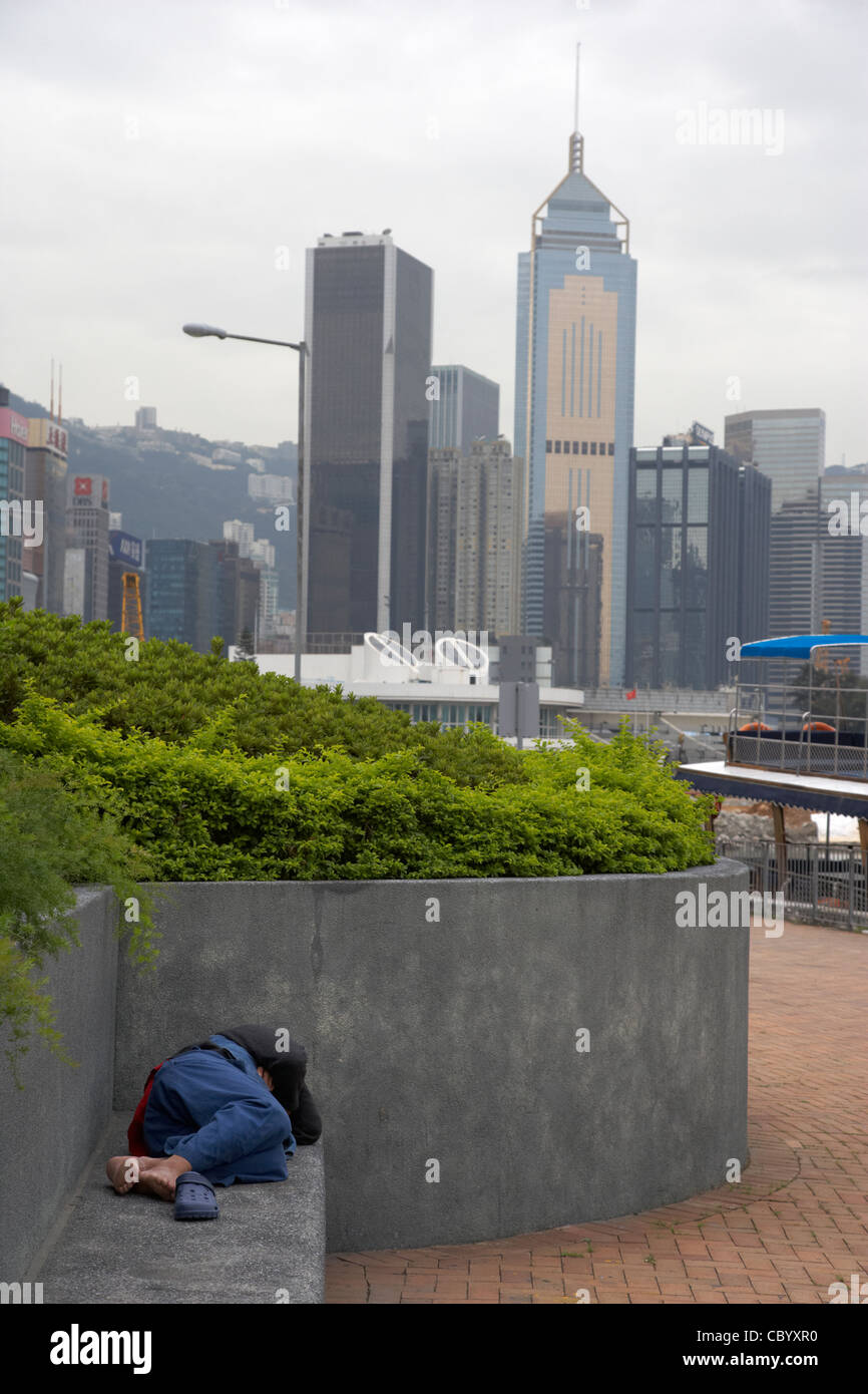 chinese man sleeping outdoors on a park bench in causeway bay hong kong ...