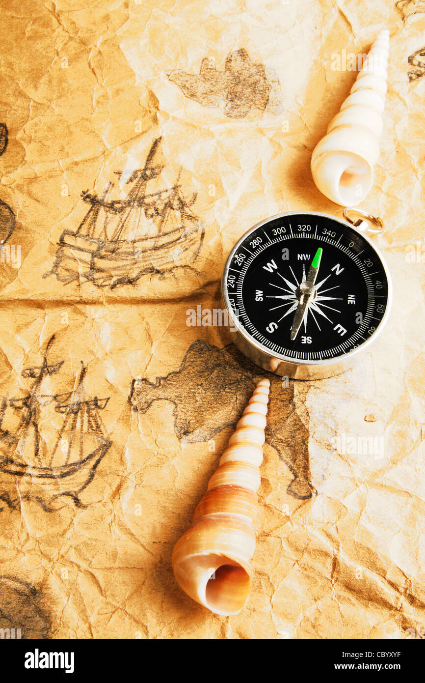 Compass and shells on old marine map Stock Photo - Alamy
