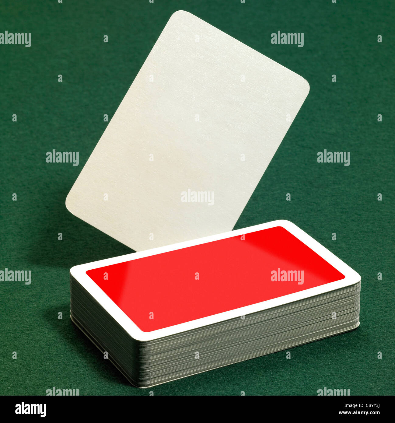 low angle studio photography showing a stack of red playing cards on ...