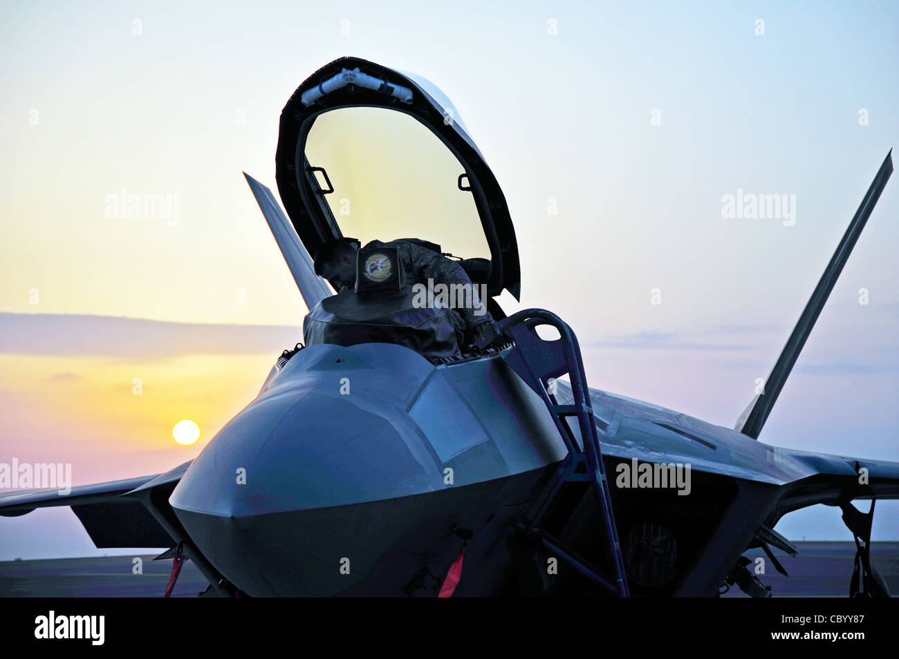 The sun sets behind an F-22 Raptor recently at an airfield in Southwest ...