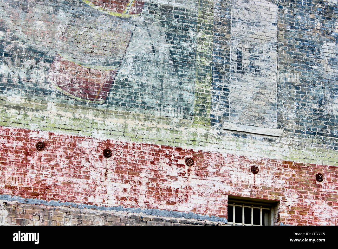 Colorful faded advertisements on old brick warehouse Stock Photo - Alamy
