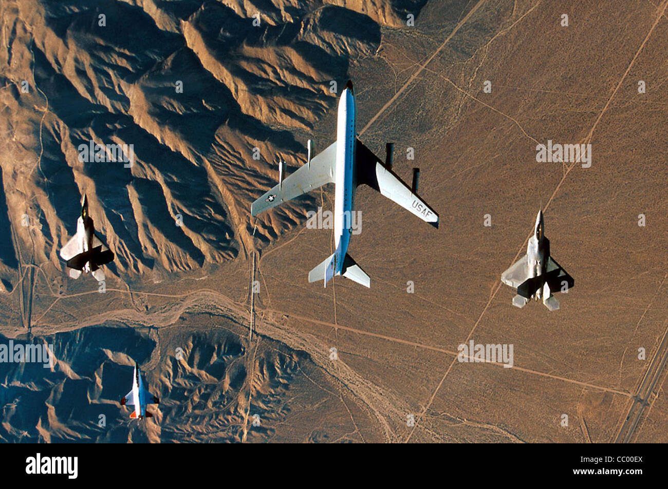 EDWARDS AIR FORCE BASE, Calif. -- Two F-22 Raptors flank a KC-135 ...