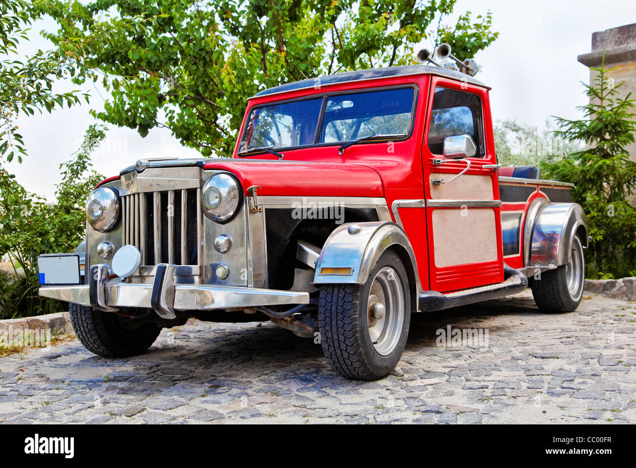 Dusty pickup hot road parked on crazy paving hard standing, landscape ...