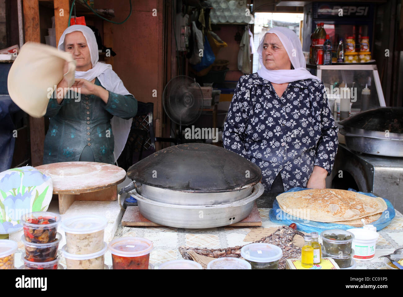 DRUZE WOMEN COOKING PANCAKES IN THE BAZAAR OF CARMEL, TEL AVIV, ISRAEL ...