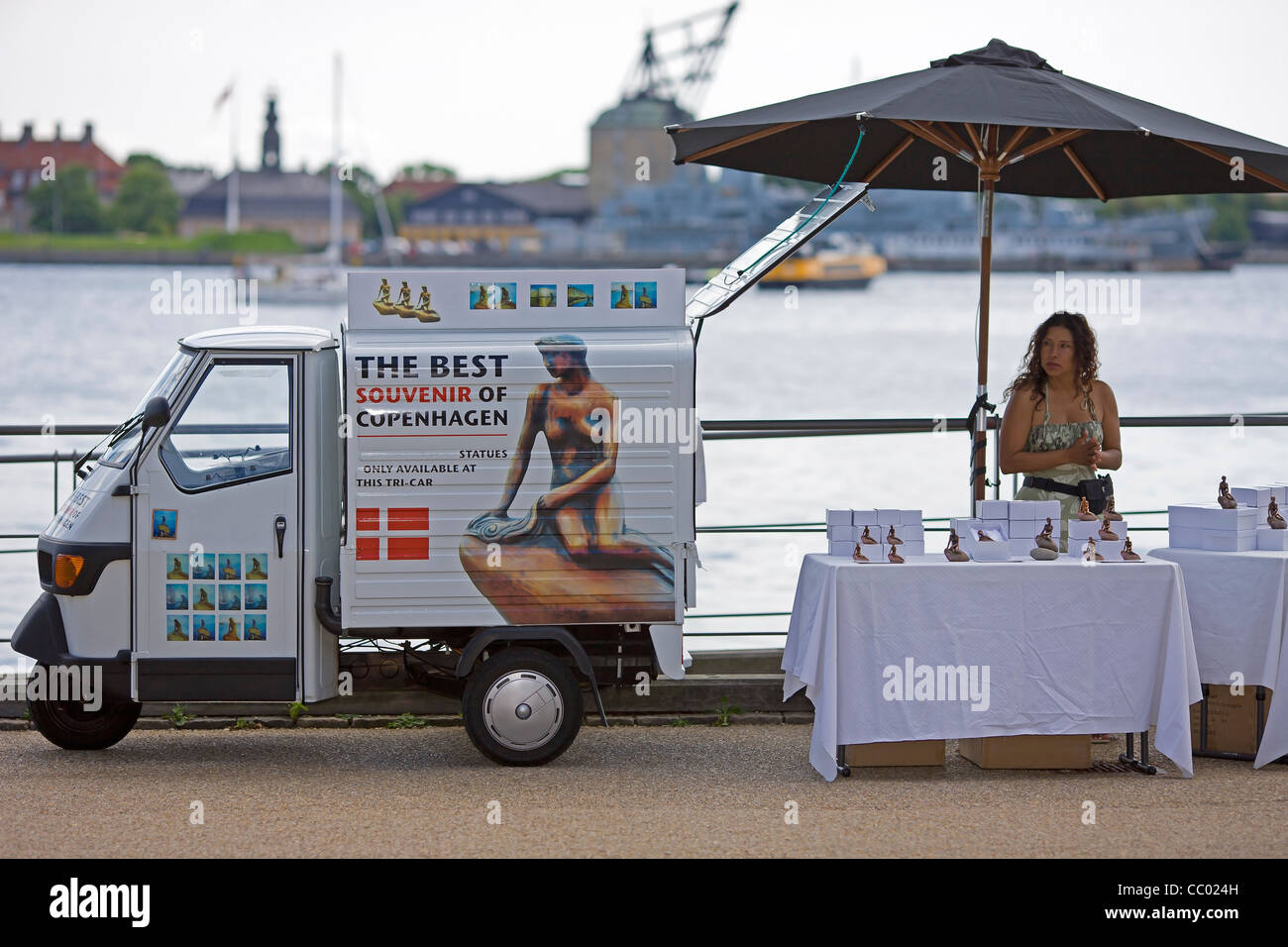Business woman selling souvenir models of The Little Mermaid in ...