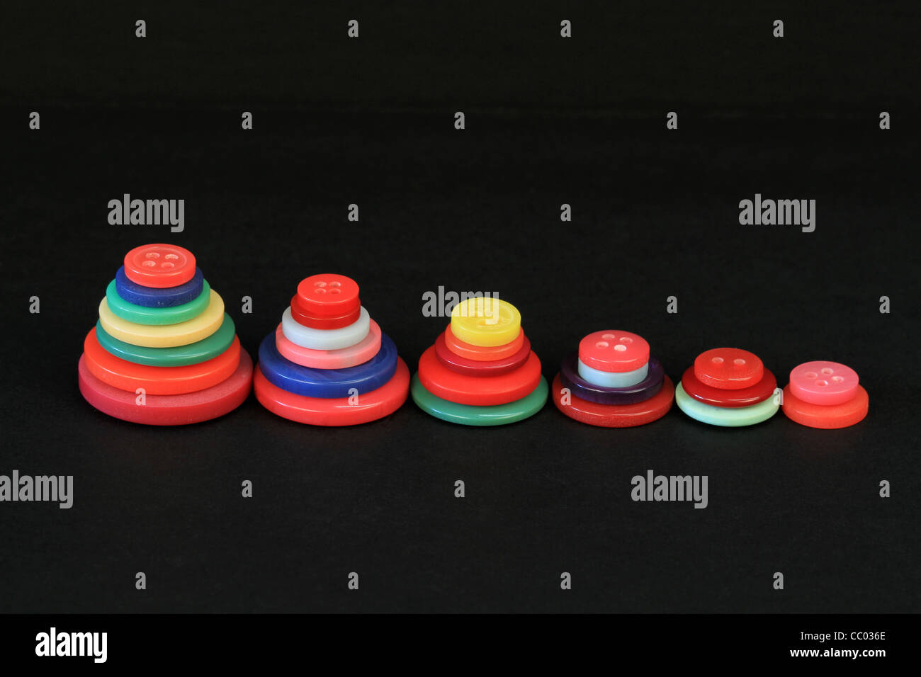 Colourful buttons stacked on top of each other Stock Photo - Alamy
