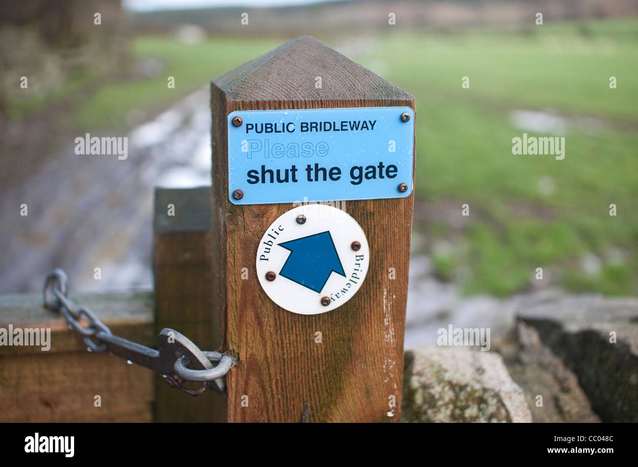 Public Bridleway sign on gatepost reminding walkers and riders to ...