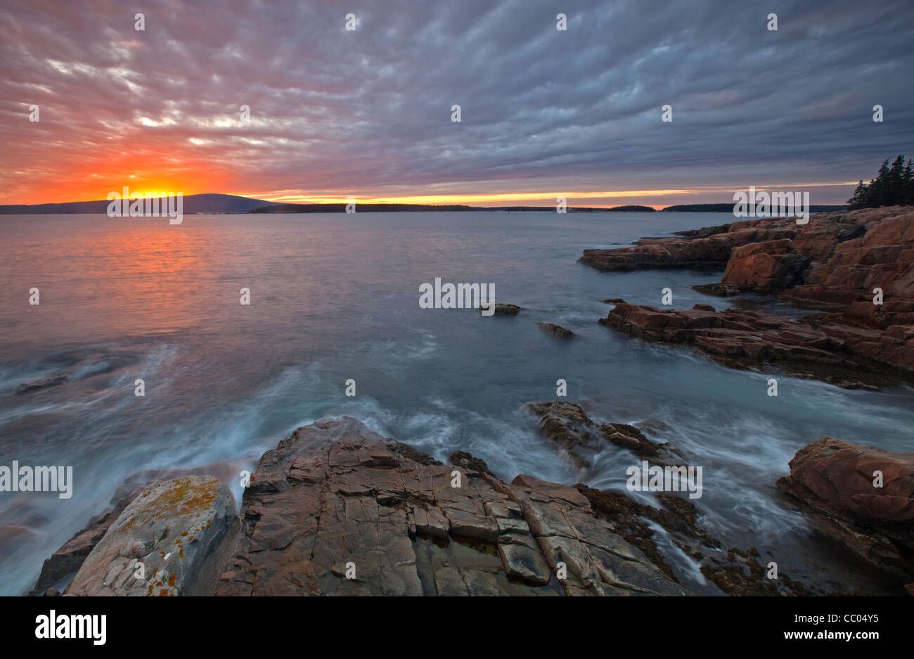 Sunset over Cadillac Mountain as seen from the coastline on the ...