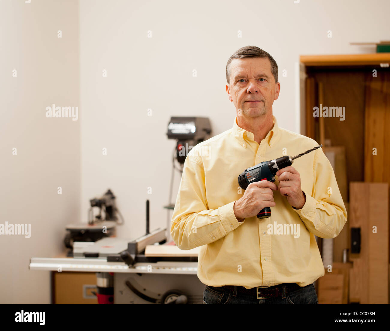 Man holding large drill hi-res stock photography and images - Alamy