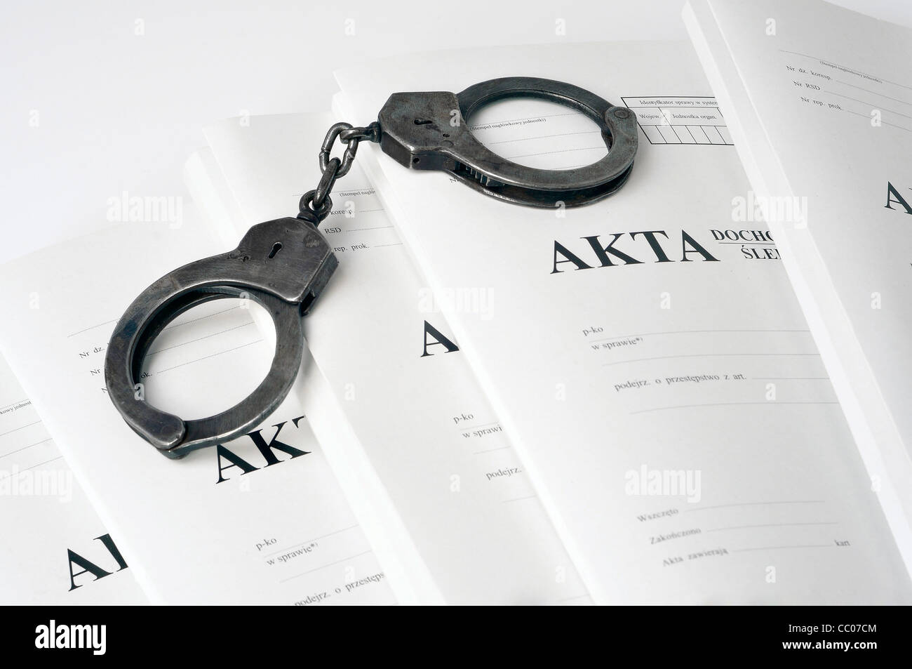 handcuffs and case file (Polish Stock Photo - Alamy