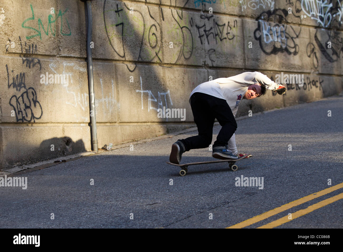 Young male skateboarder on urban street Stock Photo - Alamy