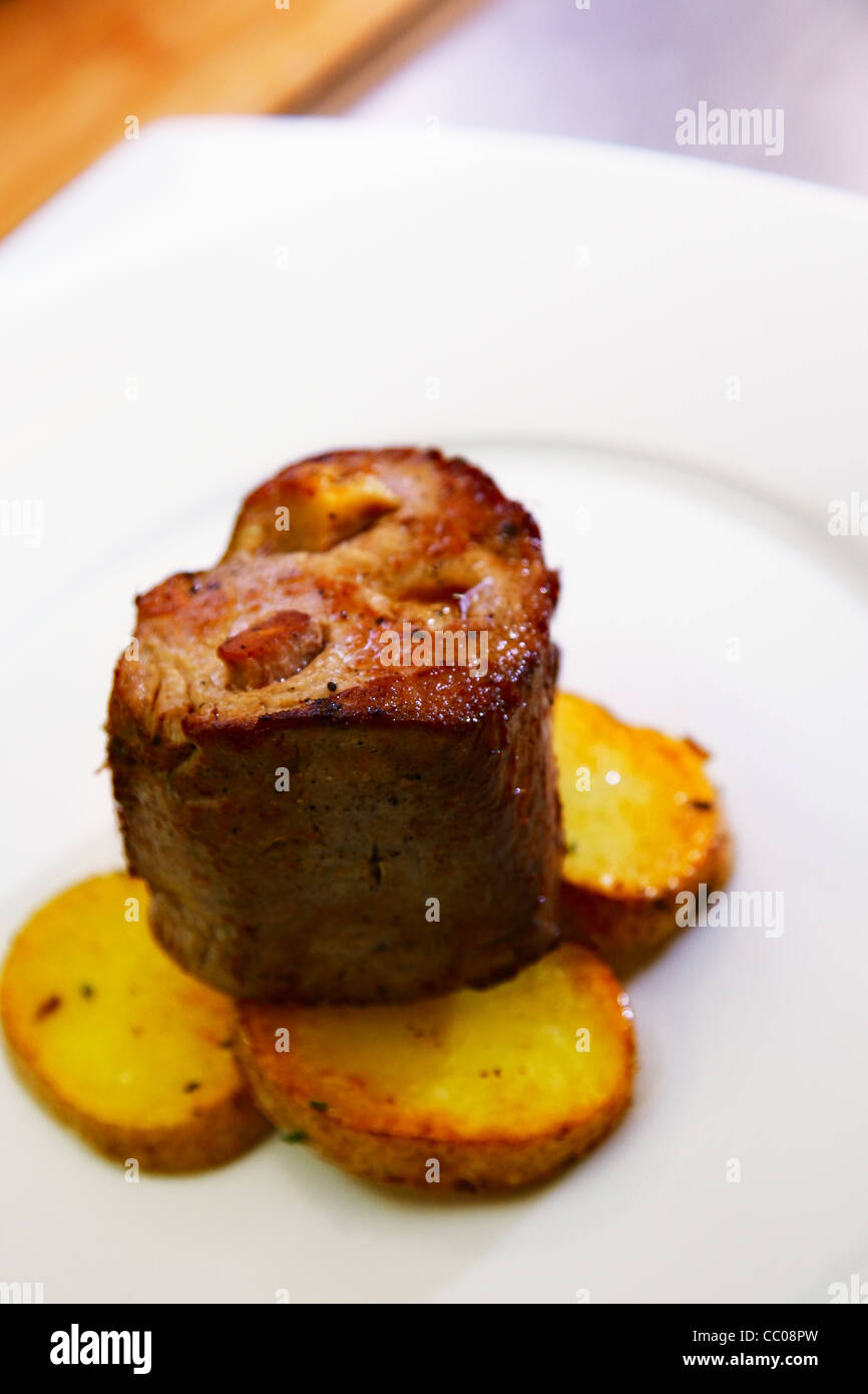 roast meat with potatoes on white plate Stock Photo - Alamy